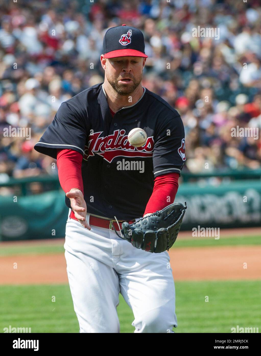 Cleveland Indians starting pitcher Corey Kluber bobbles the ball but ...