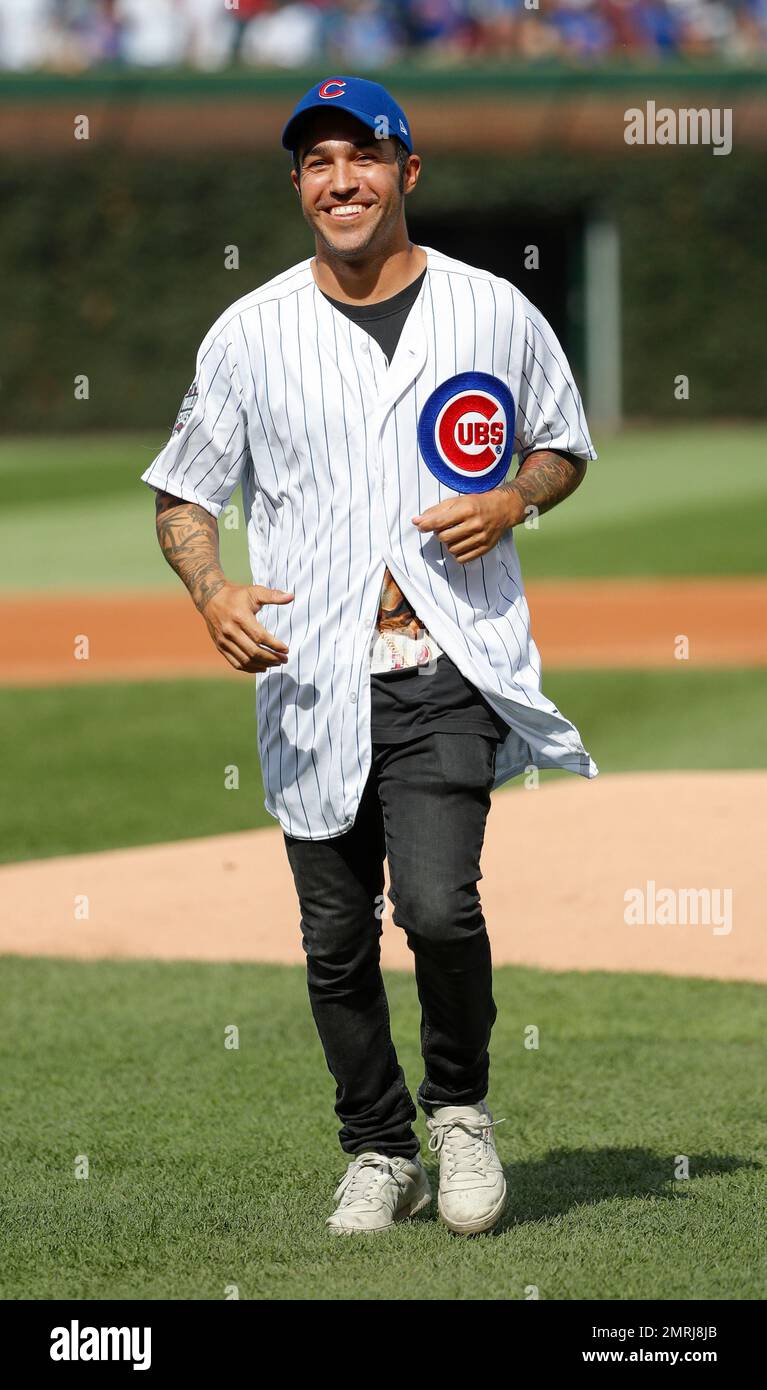 Pete Wentz, of the rock band Fall Out Boy, smiles after throwing out a ...