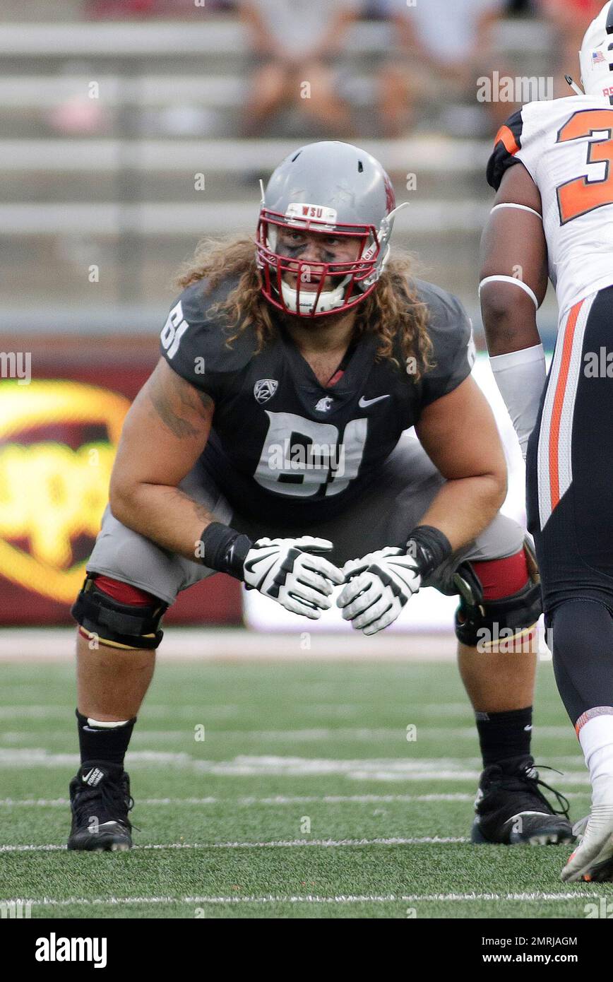 Washington State offensive lineman Cole Madison (61) lines up for a ...