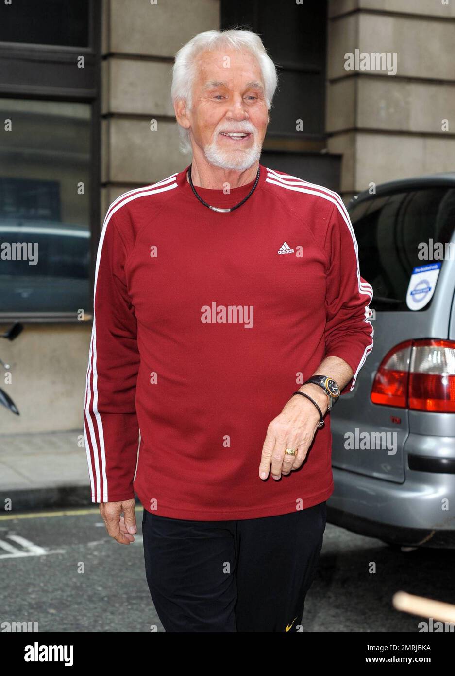 Country music legend Kenny Rogers signs autographs as he leaves the BBC ...