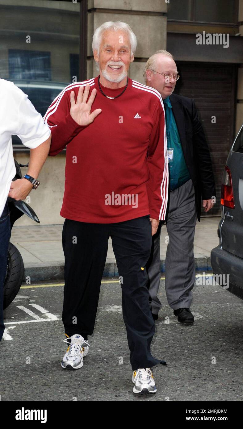 Country music legend Kenny Rogers signs autographs as he leaves the BBC ...