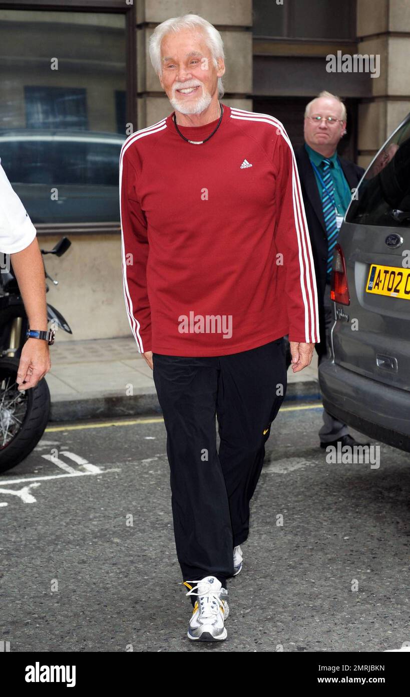 Country music legend Kenny Rogers signs autographs as he leaves the BBC ...