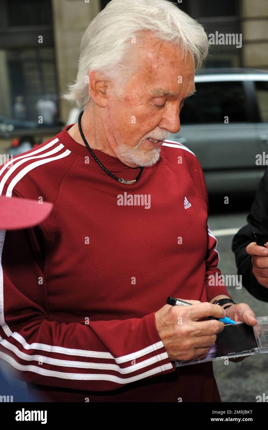 Country music legend Kenny Rogers signs autographs as he leaves the BBC ...