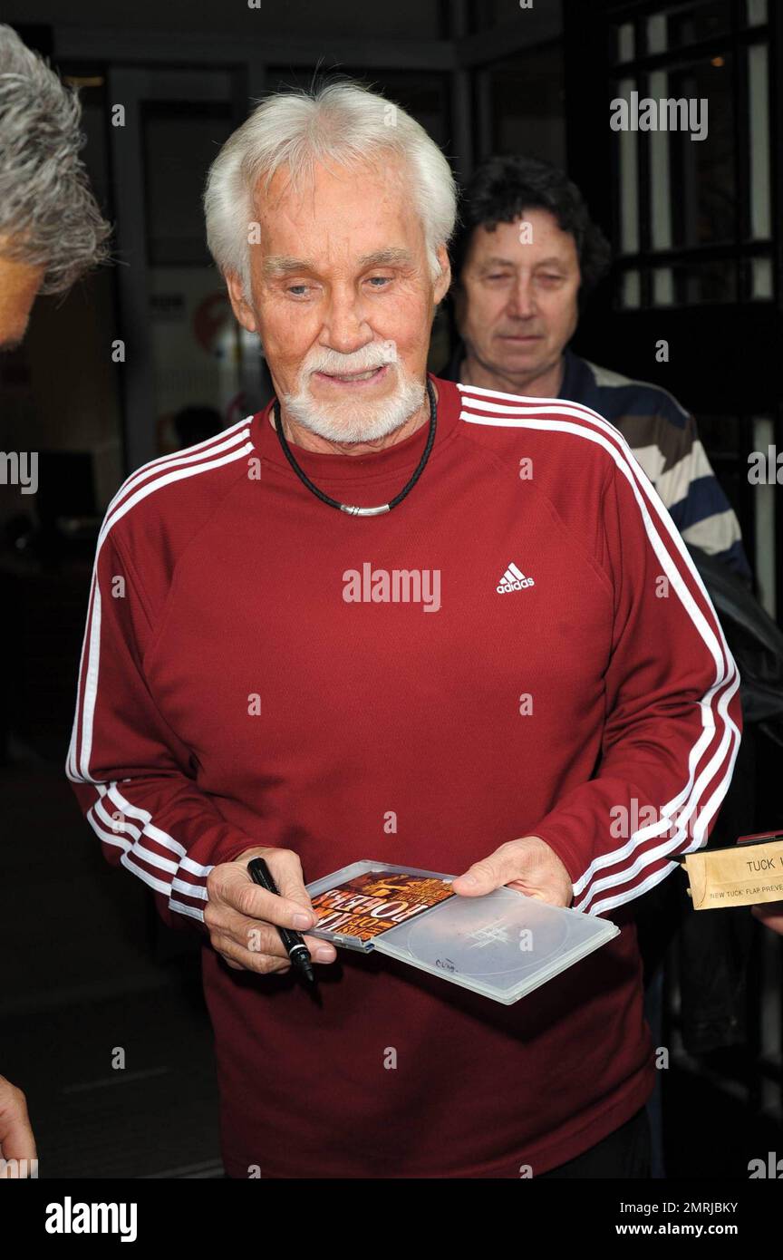 Country music legend Kenny Rogers signs autographs as he leaves the BBC ...
