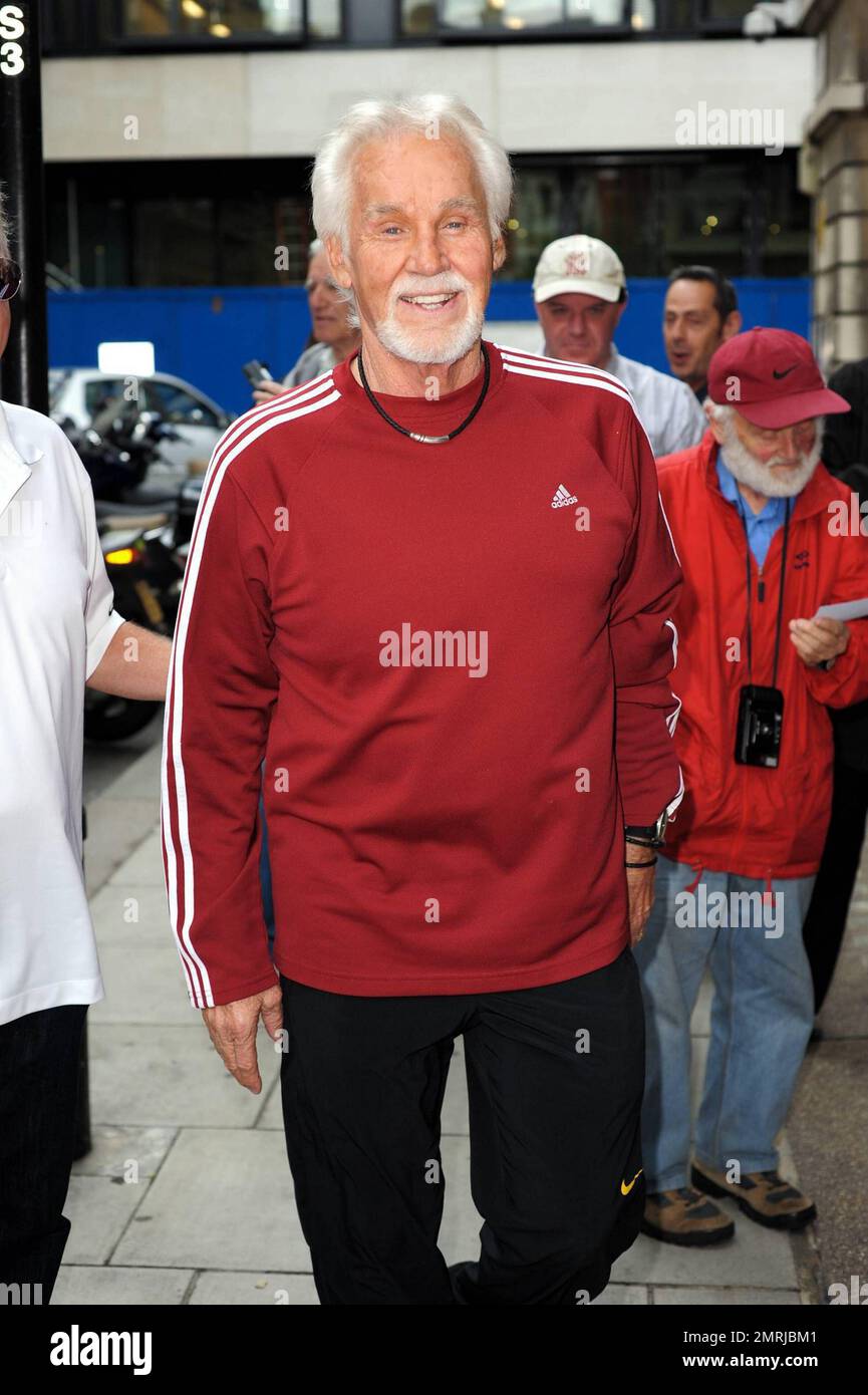 Country music legend Kenny Rogers signs autographs as he leaves the BBC ...