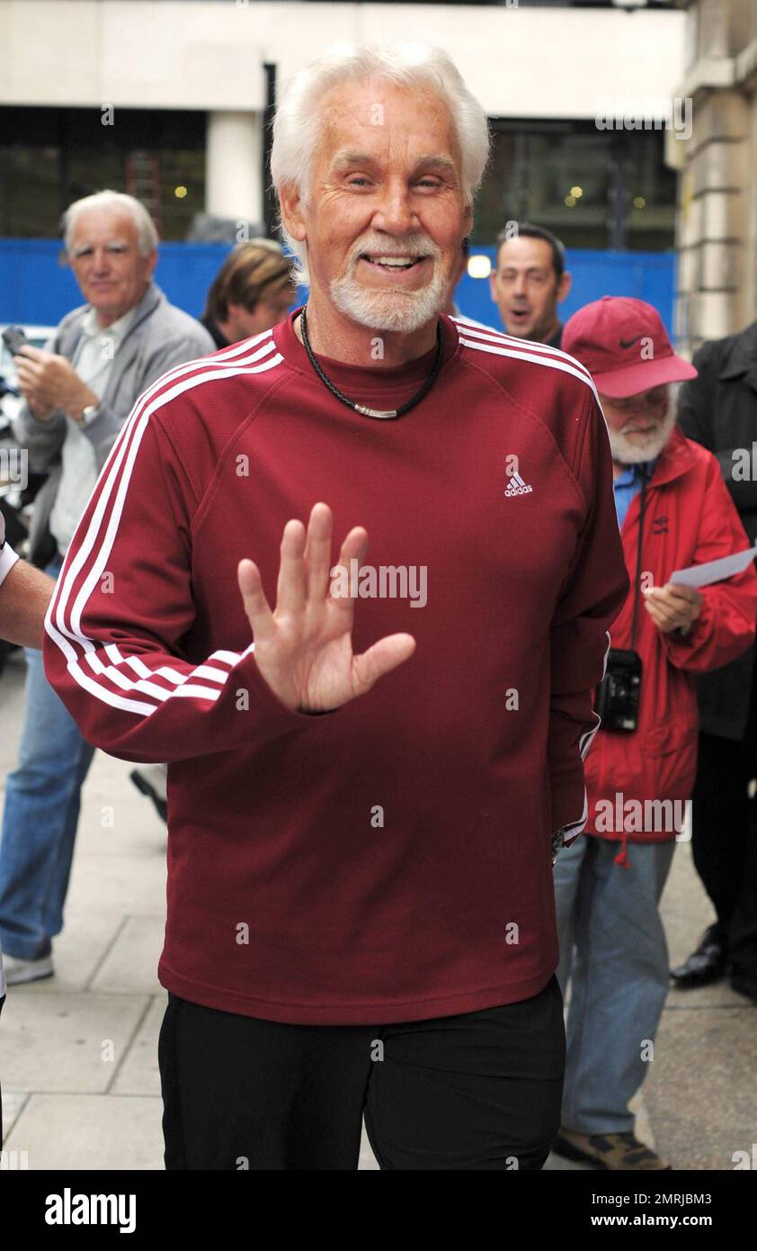 Country music legend Kenny Rogers signs autographs as he leaves the BBC ...