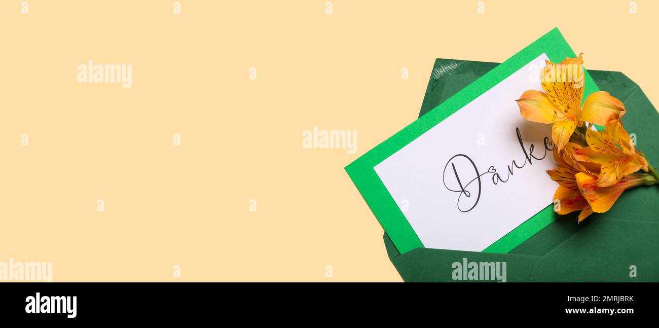 Card with word DANKE, envelope and flowers on beige background with ...