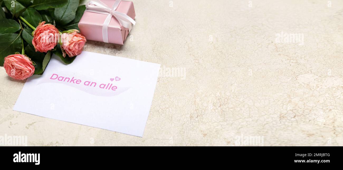 Card with text DANKE AN ALLE, roses and gift on grunge background with ...
