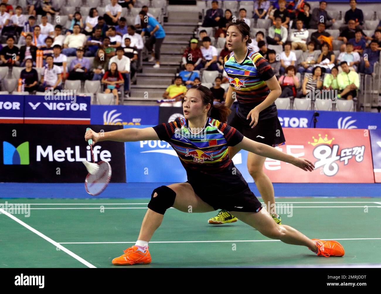 China's Huang Yaqiong returns a shot as her teammate Yu Xiaohan, rear ...