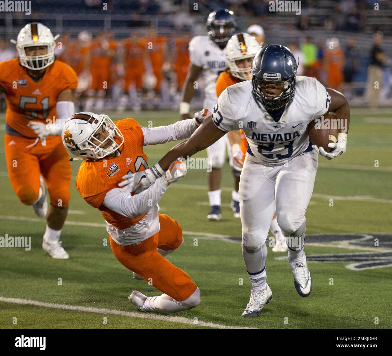 Nevada running back Kelton Moore tackled by Idaho State's Adkin Aguirre ...