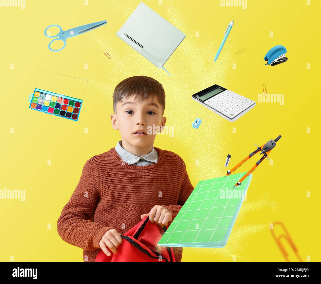 Little boy with backpack and flying school supplies on yellow ...
