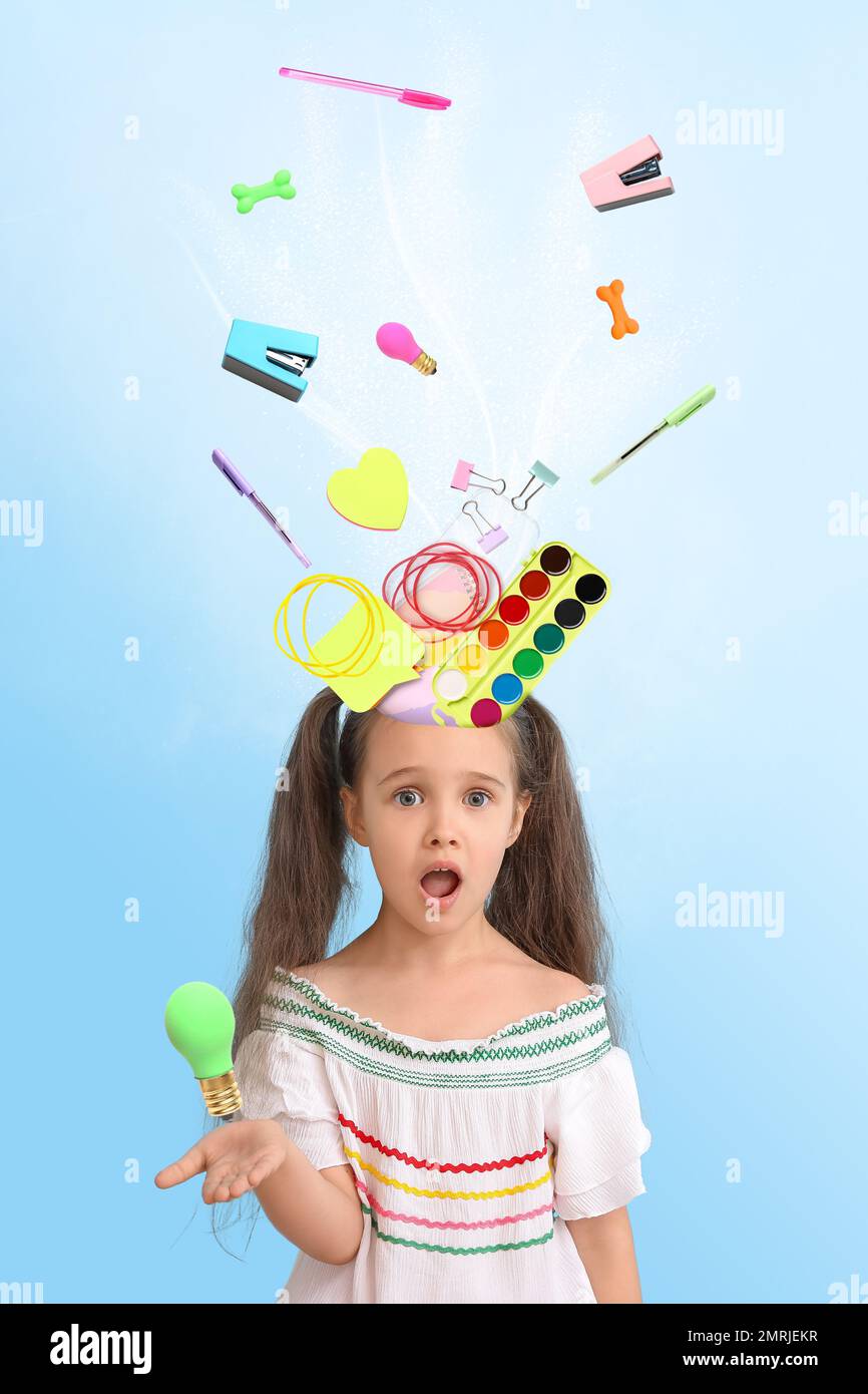 Set of school supplies flying out of girl's head on light blue ...