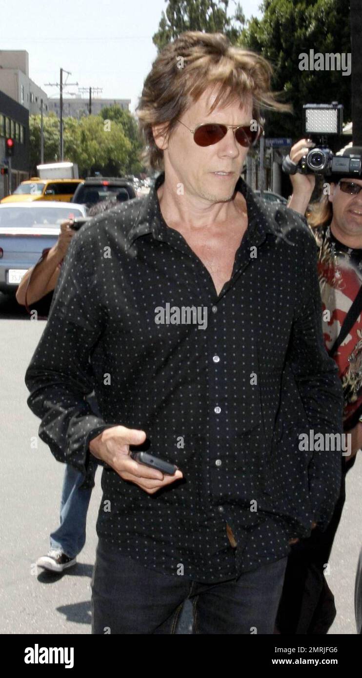 Actor Kevin Bacon gets into his Toyota Prius while out running errands ...