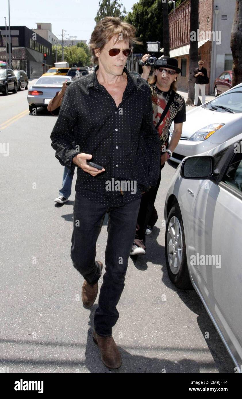 Actor Kevin Bacon gets into his Toyota Prius while out running errands ...