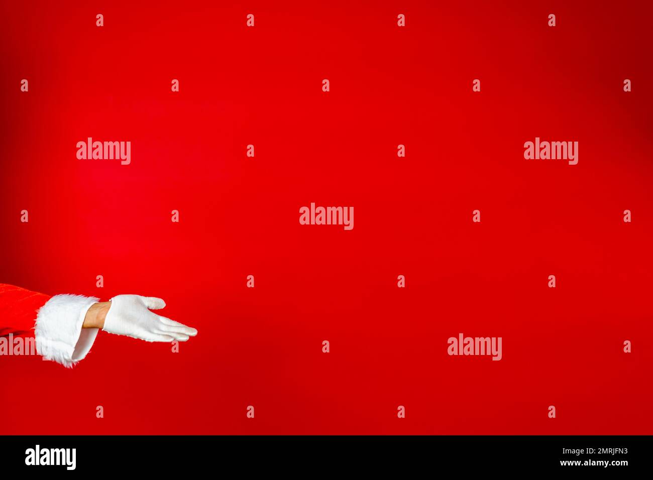 A view of the Santa Clause's hand on a red background Stock Photo - Alamy