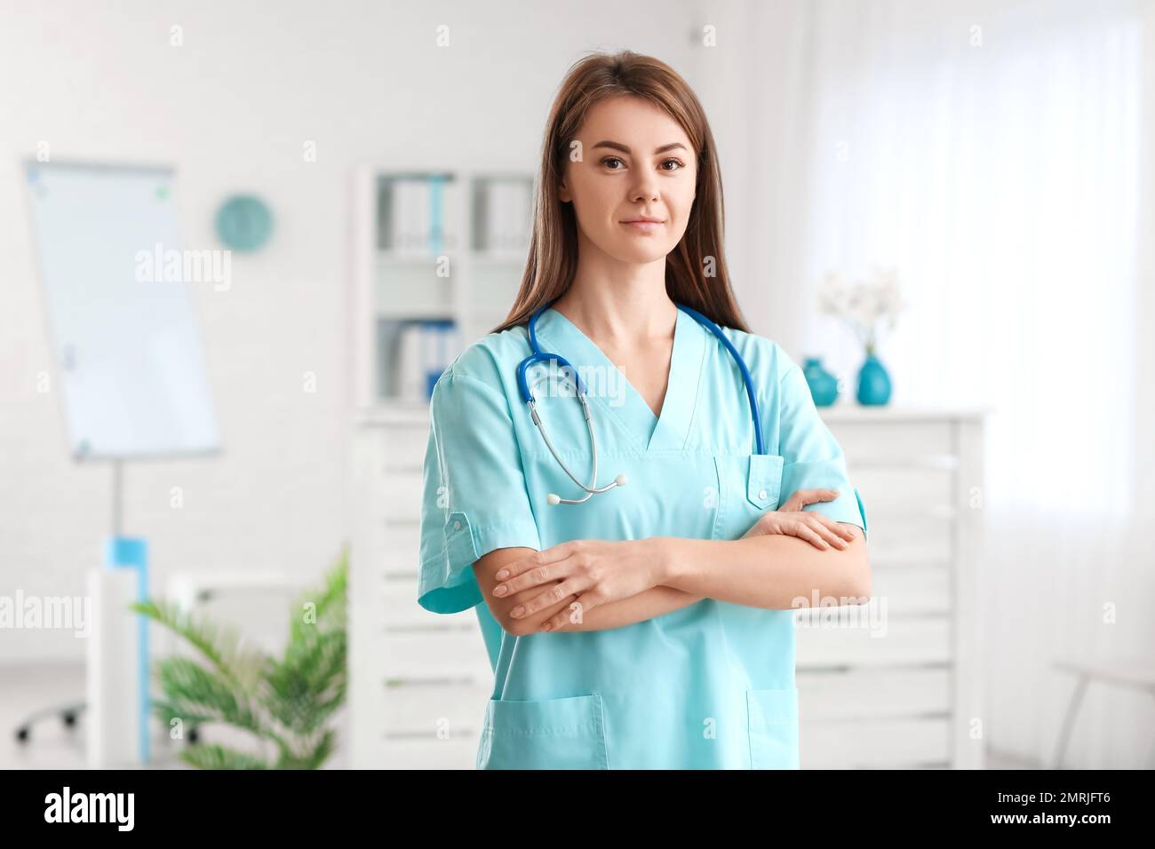 Female medical assistant with stethoscope in clinic Stock Photo - Alamy