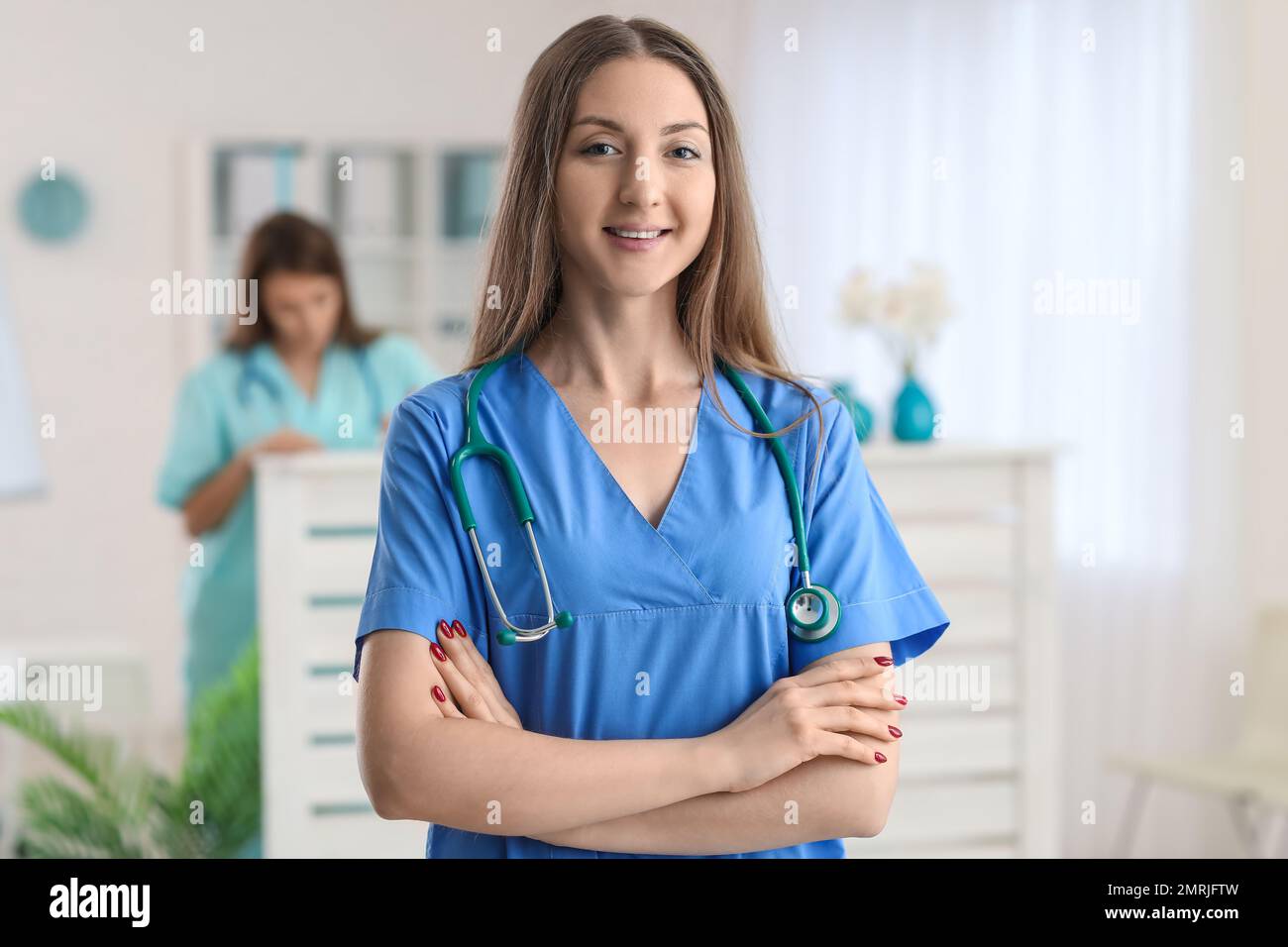 Female medical assistant with stethoscope in clinic Stock Photo - Alamy