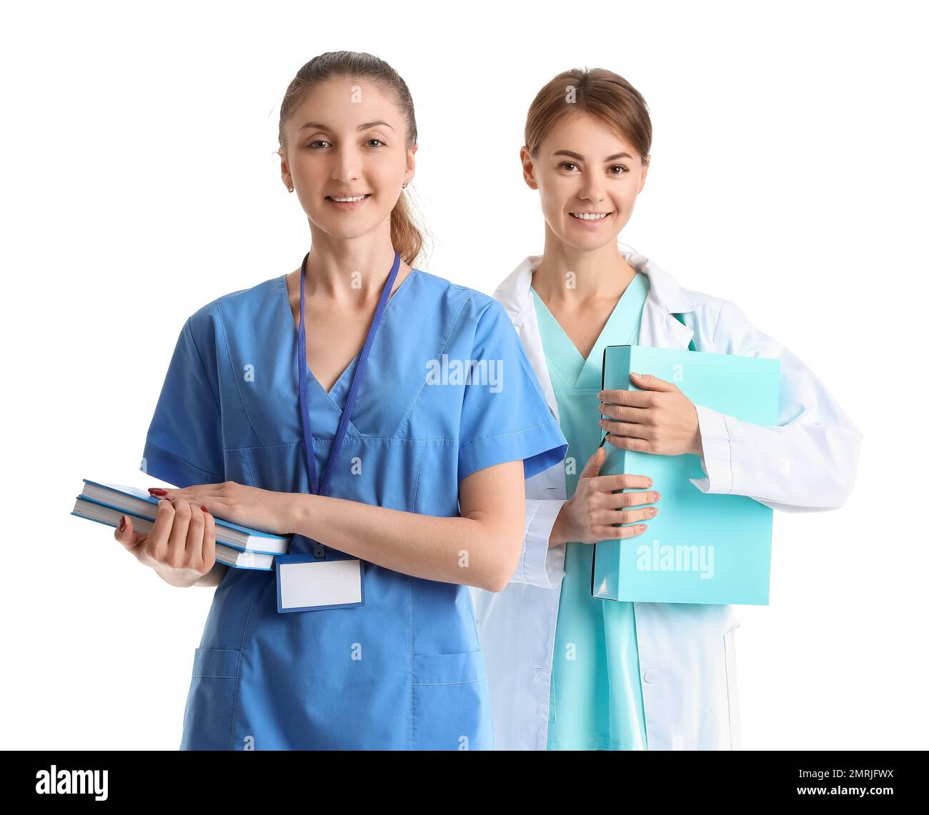Female doctor and intern with books on white background Stock Photo - Alamy