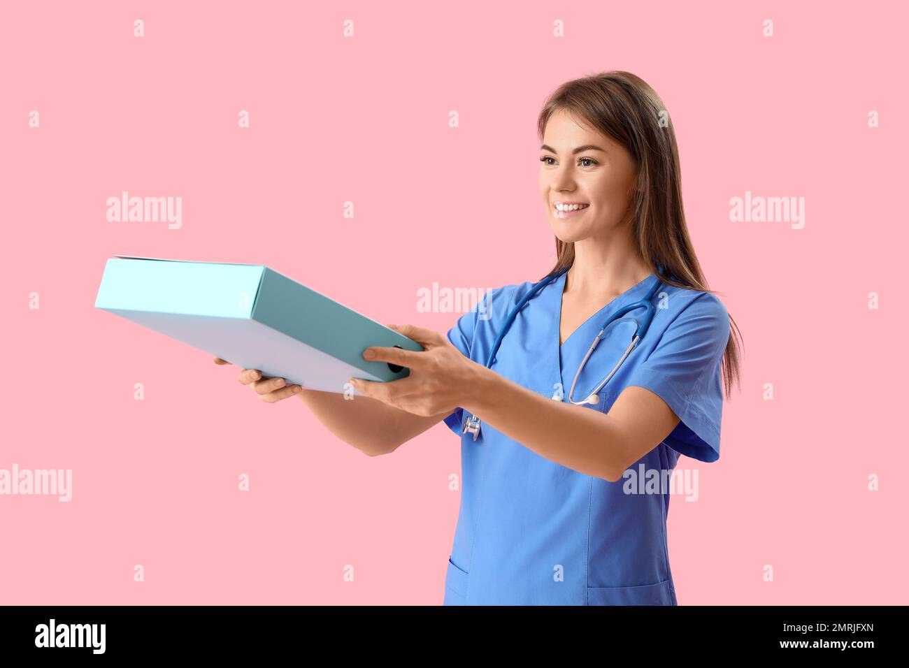 Female medical intern with folder on pink background Stock Photo - Alamy