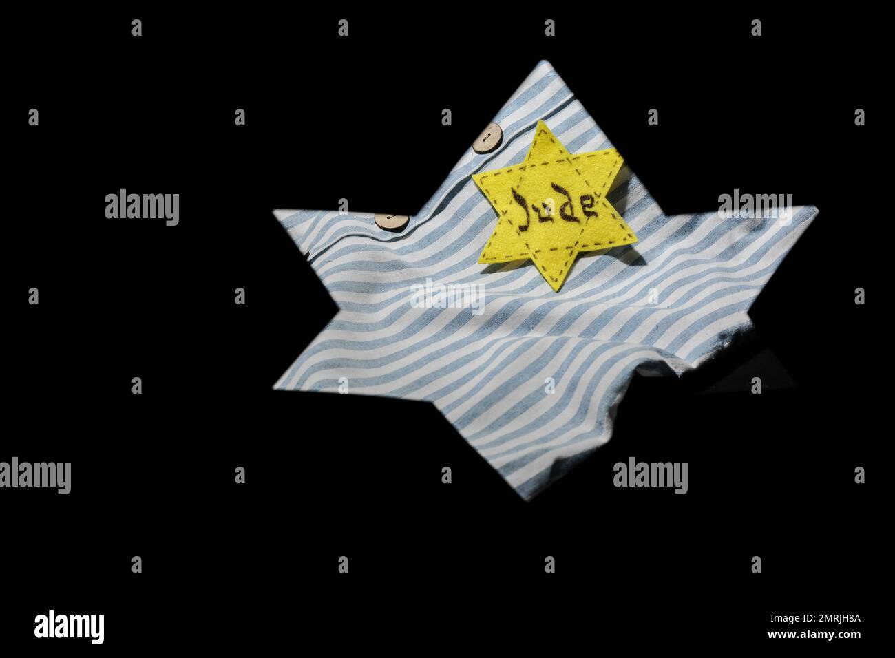 Prisoner uniform and Jewish badge visible through shape of David star ...