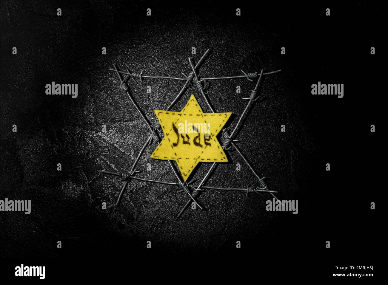 Jewish badge and barbed wire on black background. International ...