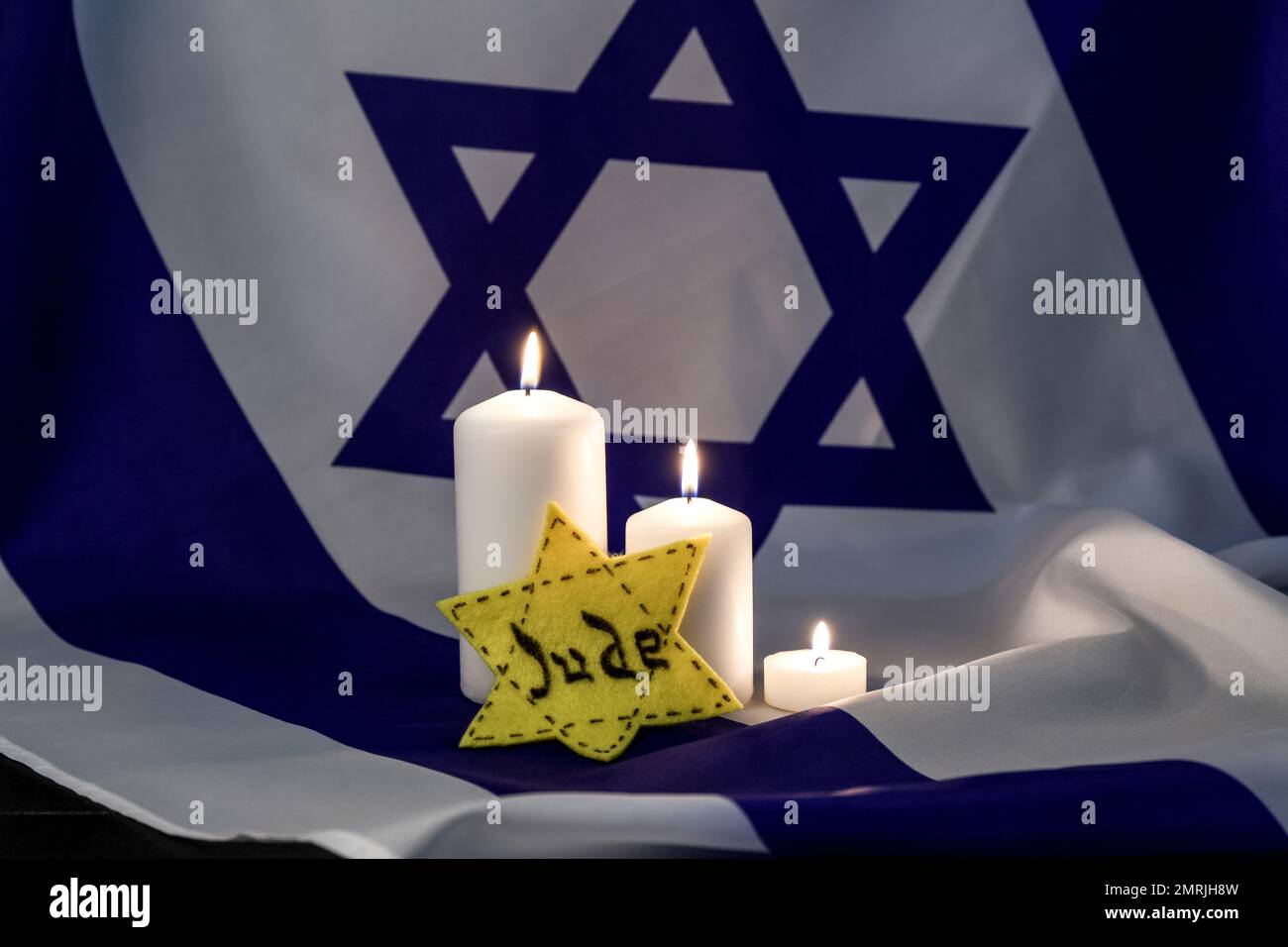 Jewish badge and burning candles on flag of Israel. International ...