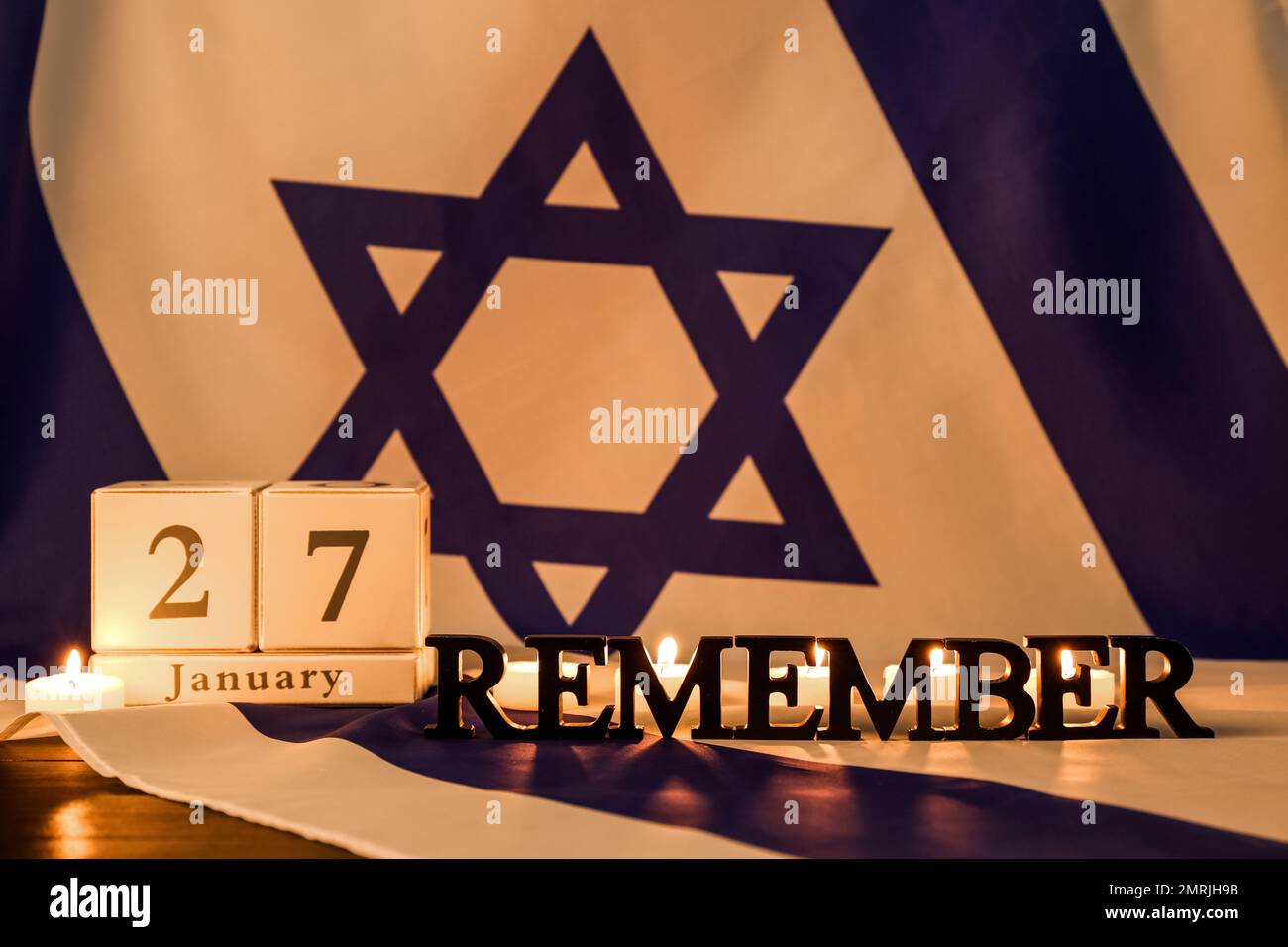 Calendar with date 27 JANUARY, word REMEMBER and burning candles on ...