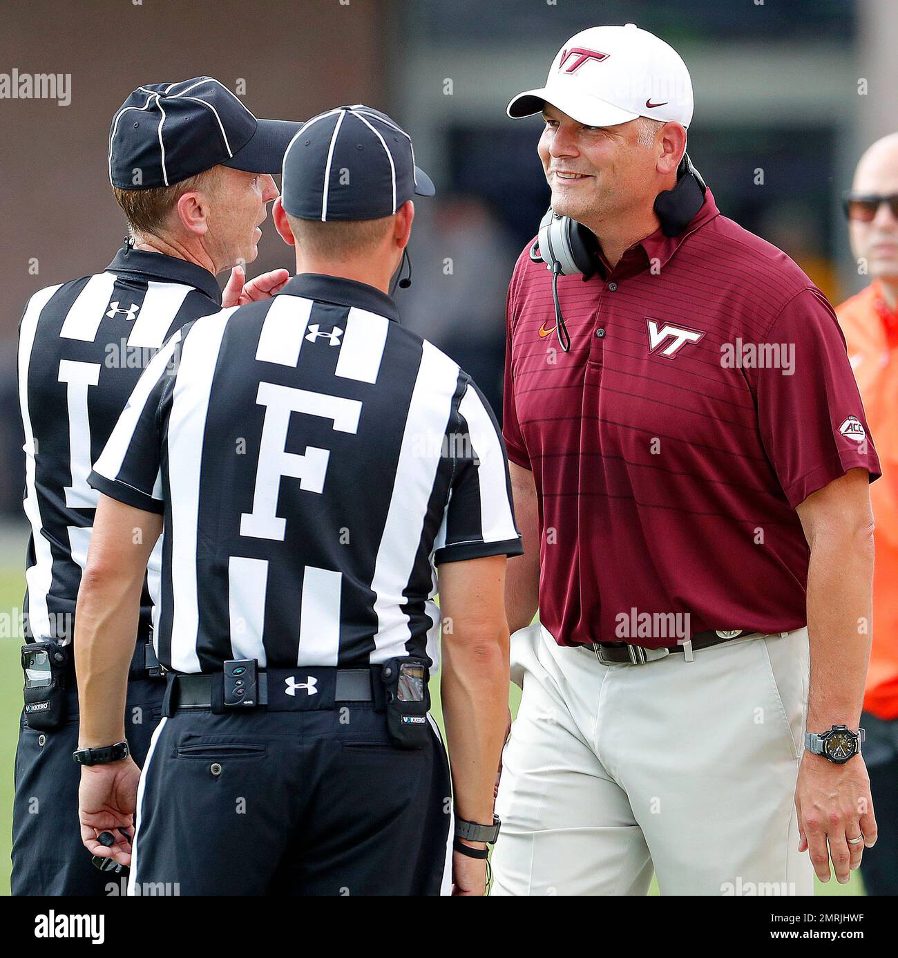 Virginia Tech head coach Justin Fuente, front right, speaks with ...