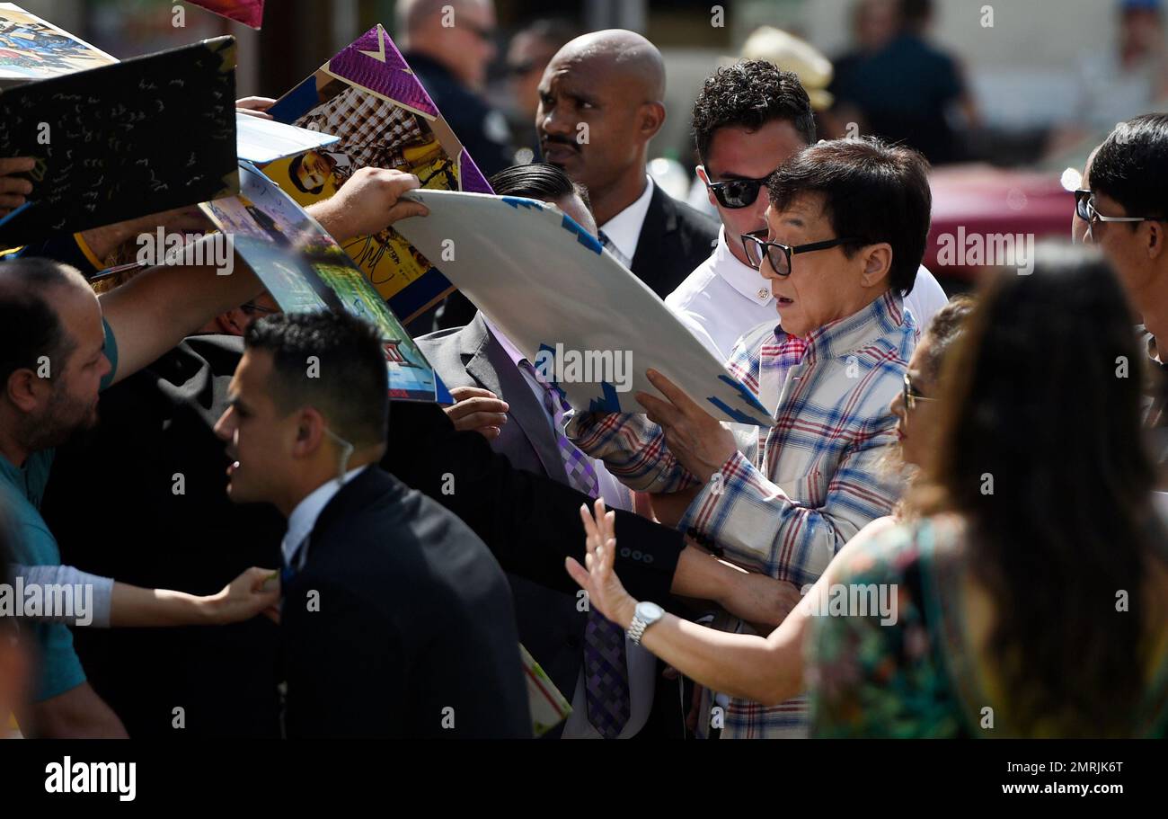 Jackie Chan, right, a cast member in "The LEGO Ninjago Movie," signs ...