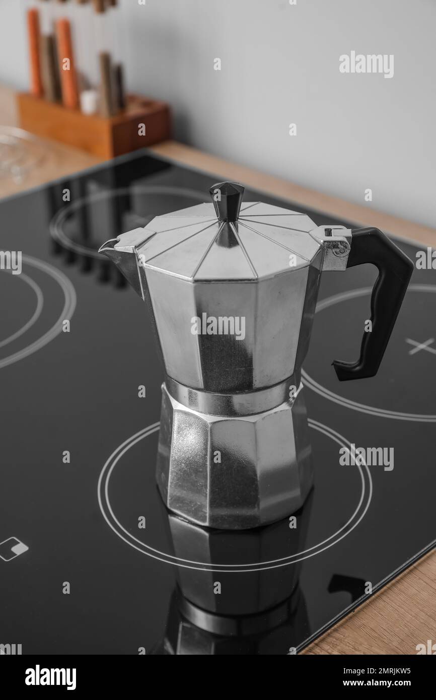 Geyser coffee maker on electric stove in kitchen Stock Photo - Alamy