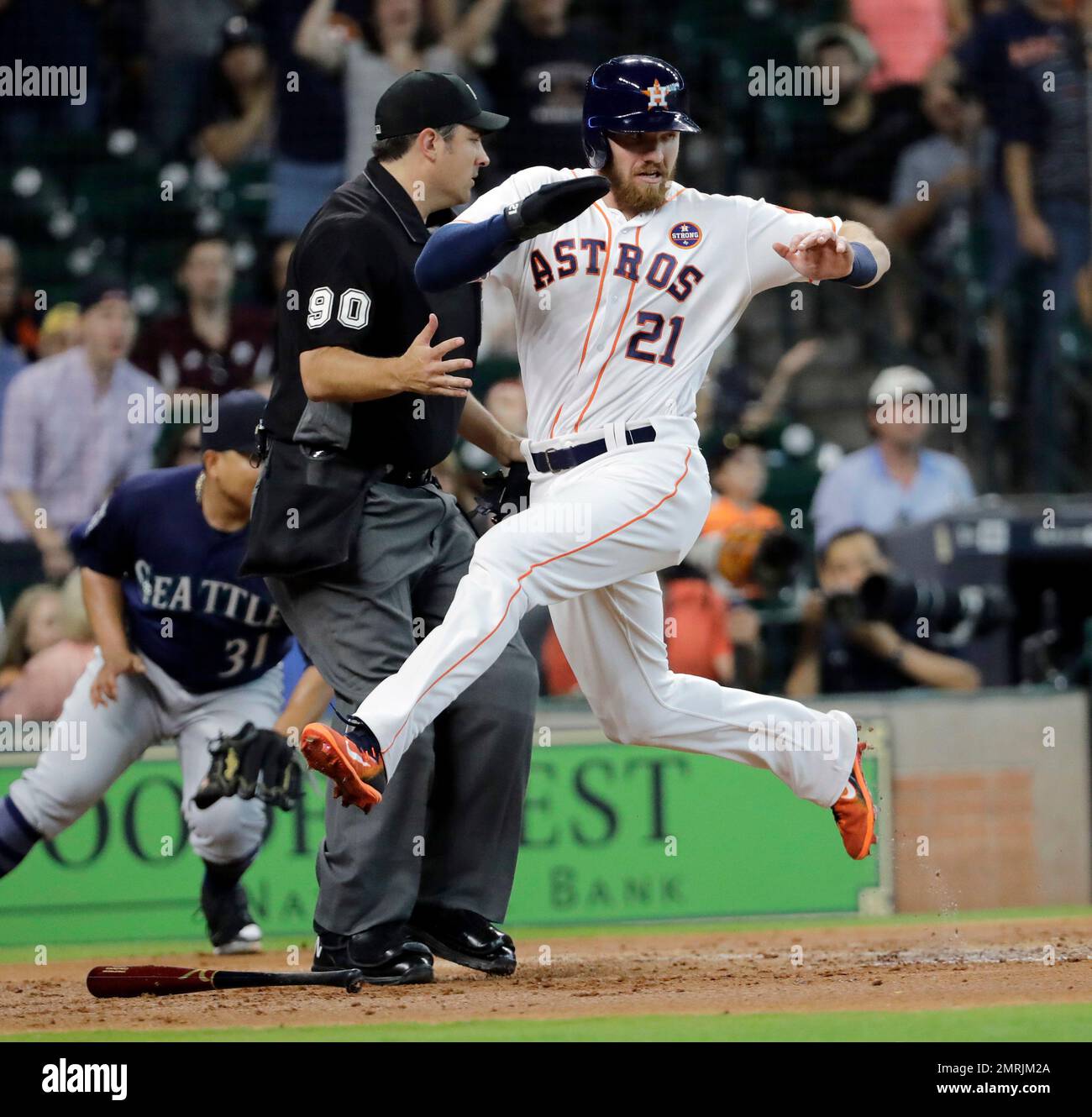 Houston Astros' Derek Fisher (21) avoids home plate umpire Mark ...