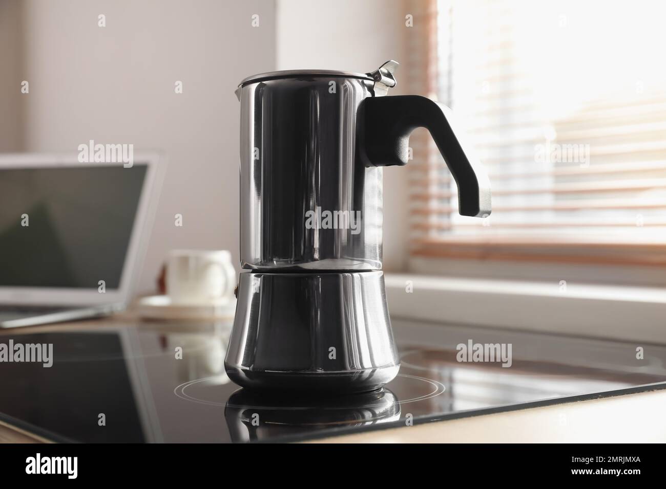 Geyser coffee maker on electric stove in kitchen near window Stock ...