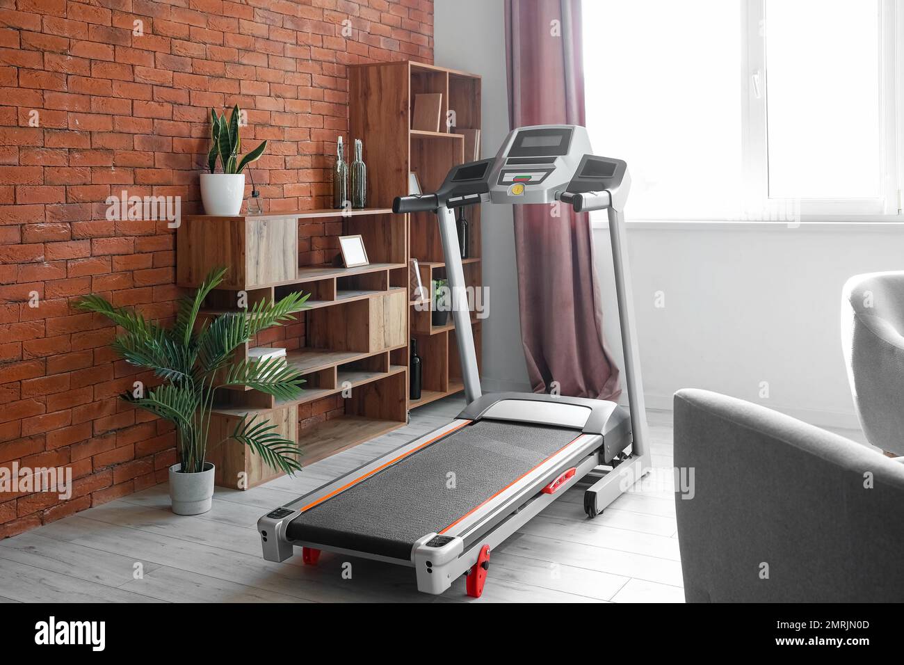 Interior of living room with modern treadmill Stock Photo - Alamy