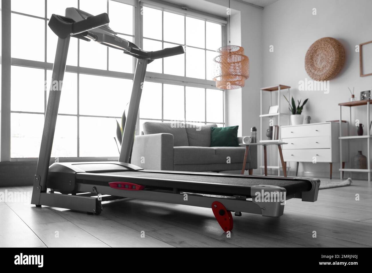Interior of living room with modern treadmill near window Stock Photo ...