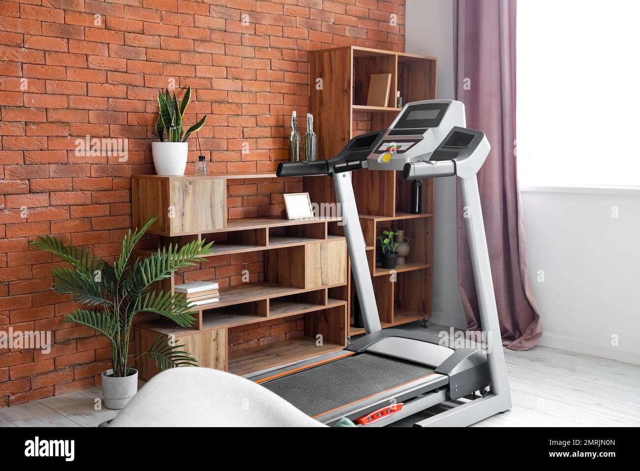 Interior of living room with modern treadmill Stock Photo - Alamy