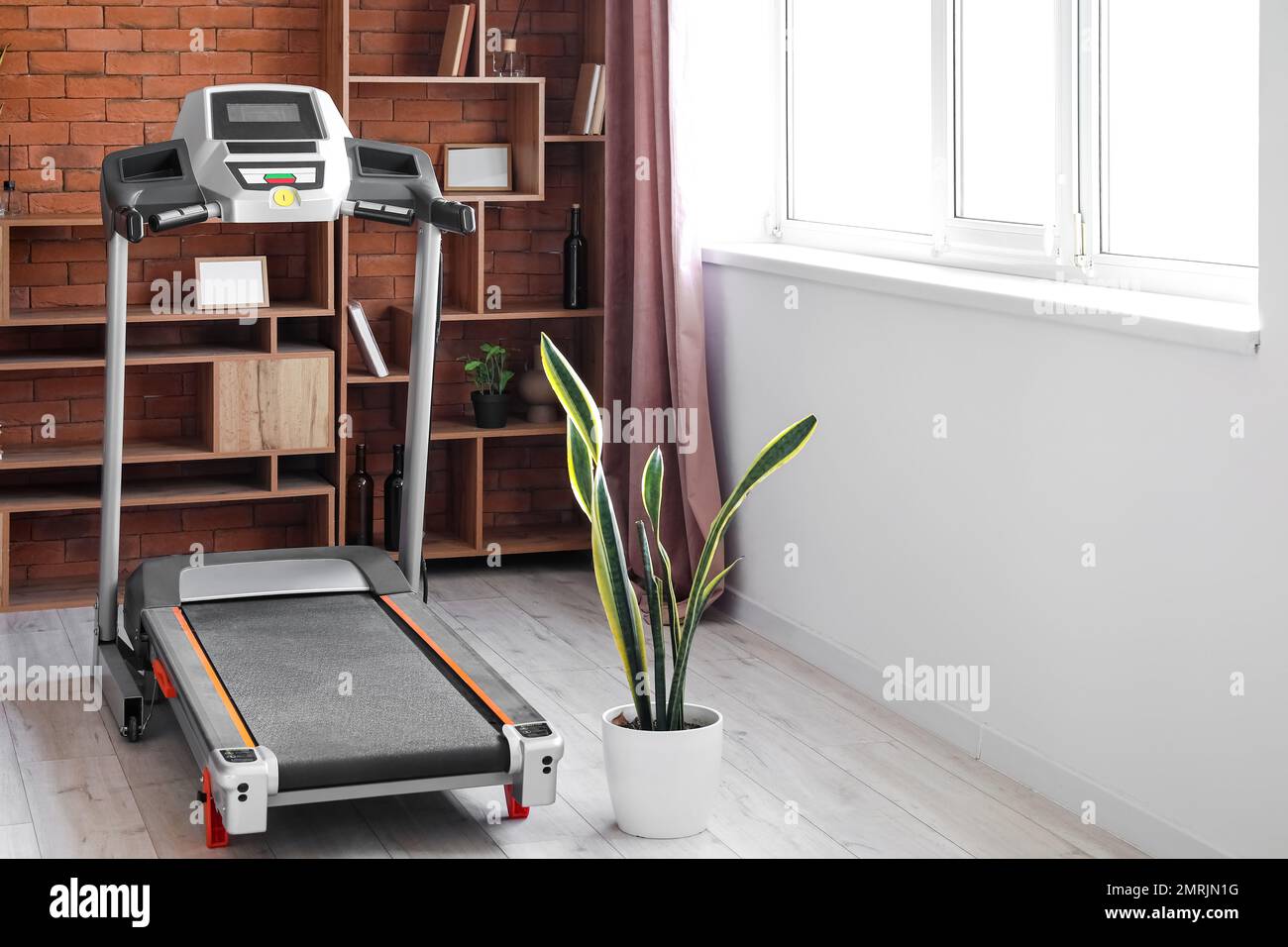 Interior of living room with modern treadmill Stock Photo - Alamy
