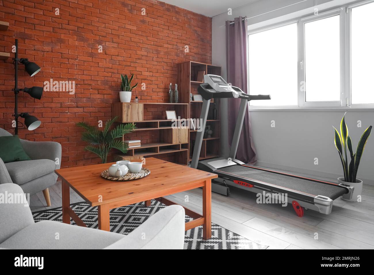 Interior of living room with modern treadmill Stock Photo - Alamy