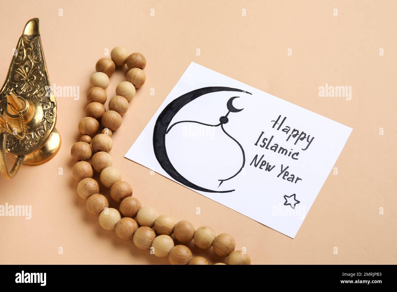 Card with text HAPPY ISLAMIC NEW YEAR, Aladdin lamp and prayer beads on ...