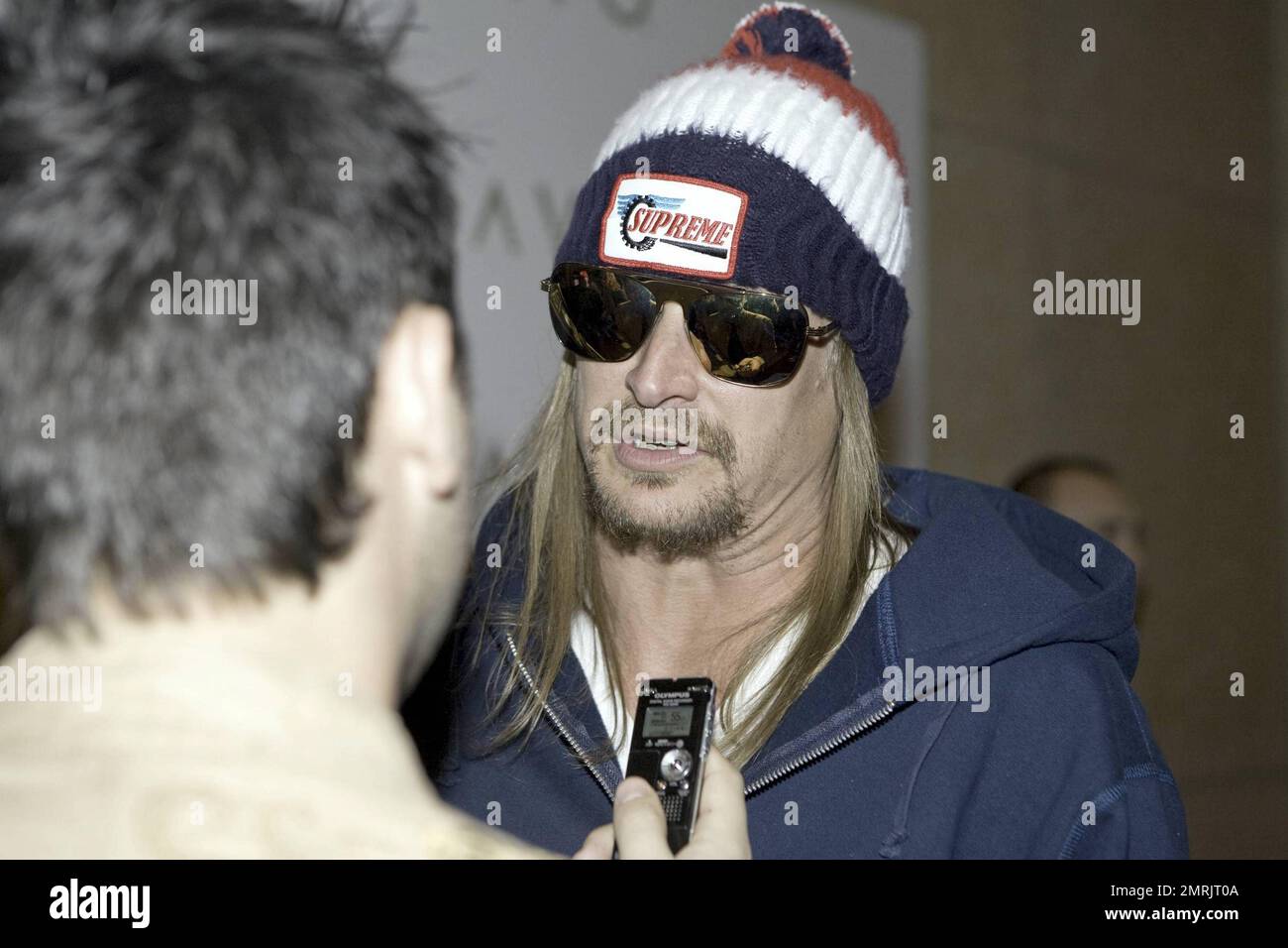 Rocker Kid Rock brings a long a cigar and a bottle of Jack Daniels as ...
