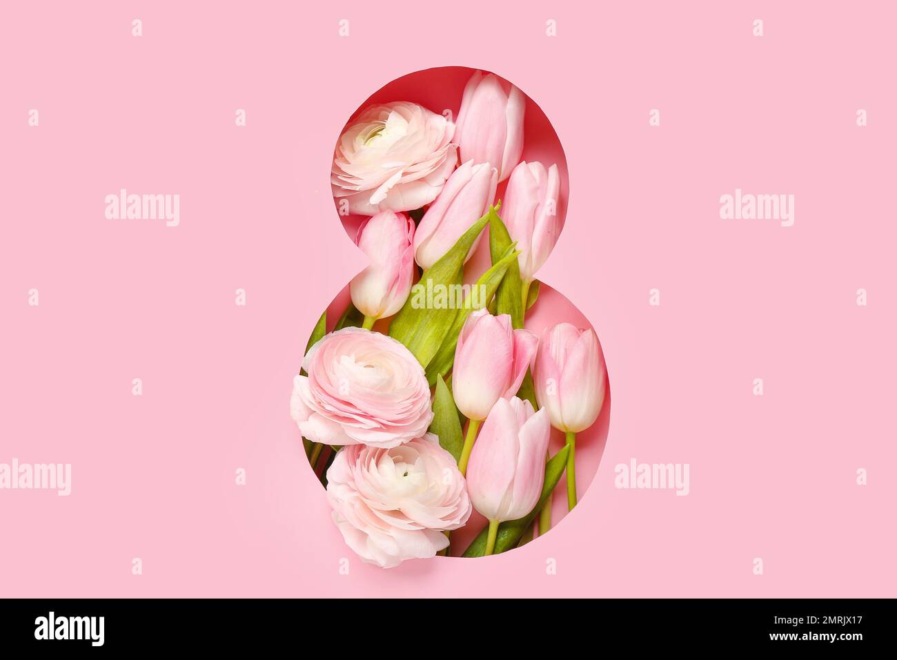 Spring flowers visible through cut pink paper in shape of figure 8 ...