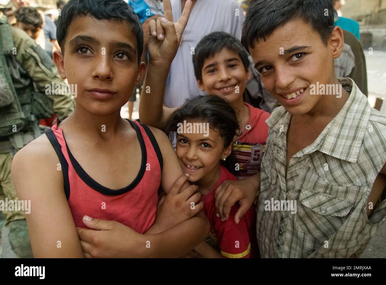 Syrian children pose for a photographer in the city of Deir ez-Zor ...