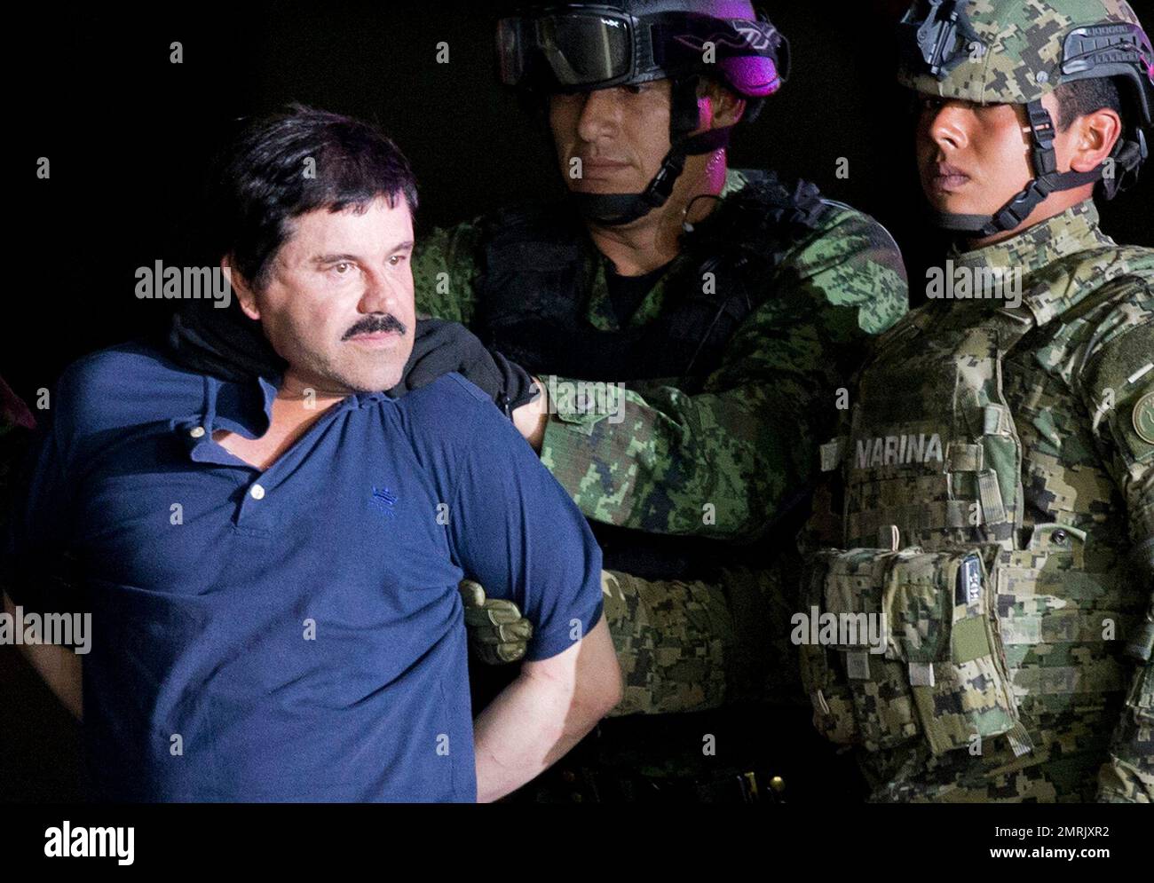 FILE - In this Jan. 8, 2016 file photo, a handcuffed Joaquin "El Chapo ...