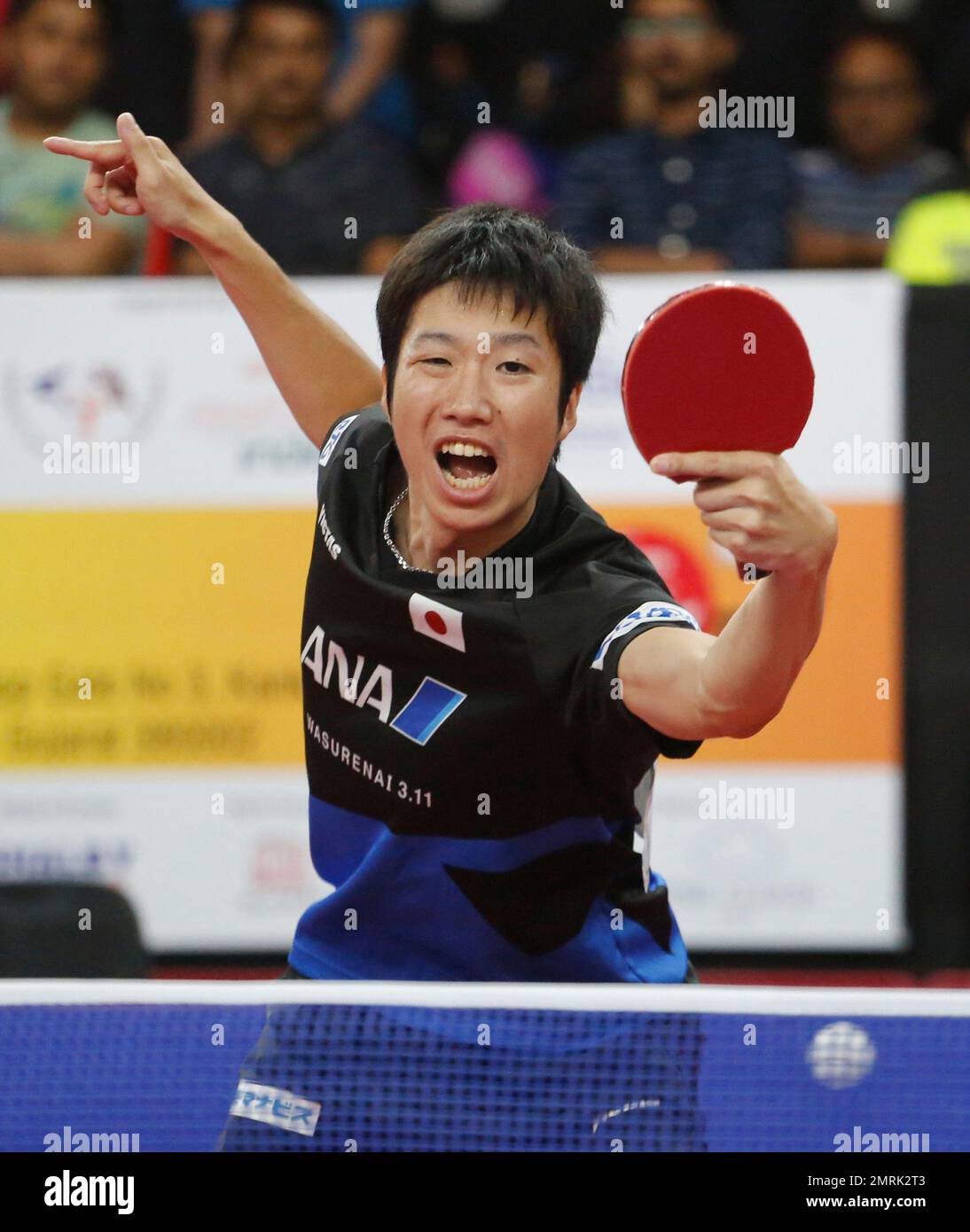 Japan's Jun Mizutani returns shot from South Korea's Lee Sangsu during the 30th Table Tennis ...