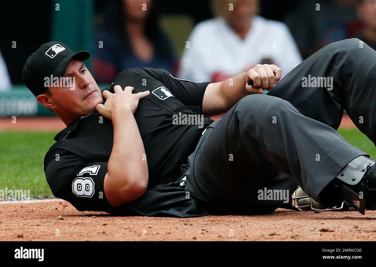 Home plate umpire Quinn Wolcott lays on the ground after getting hit by ...