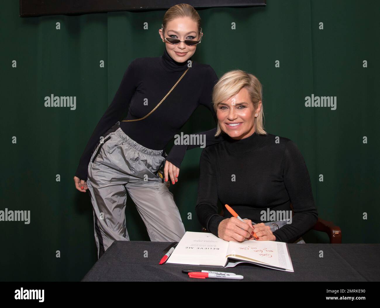Yolanda Hadid, right, signs for her daughter Gigi Hadid during a book ...
