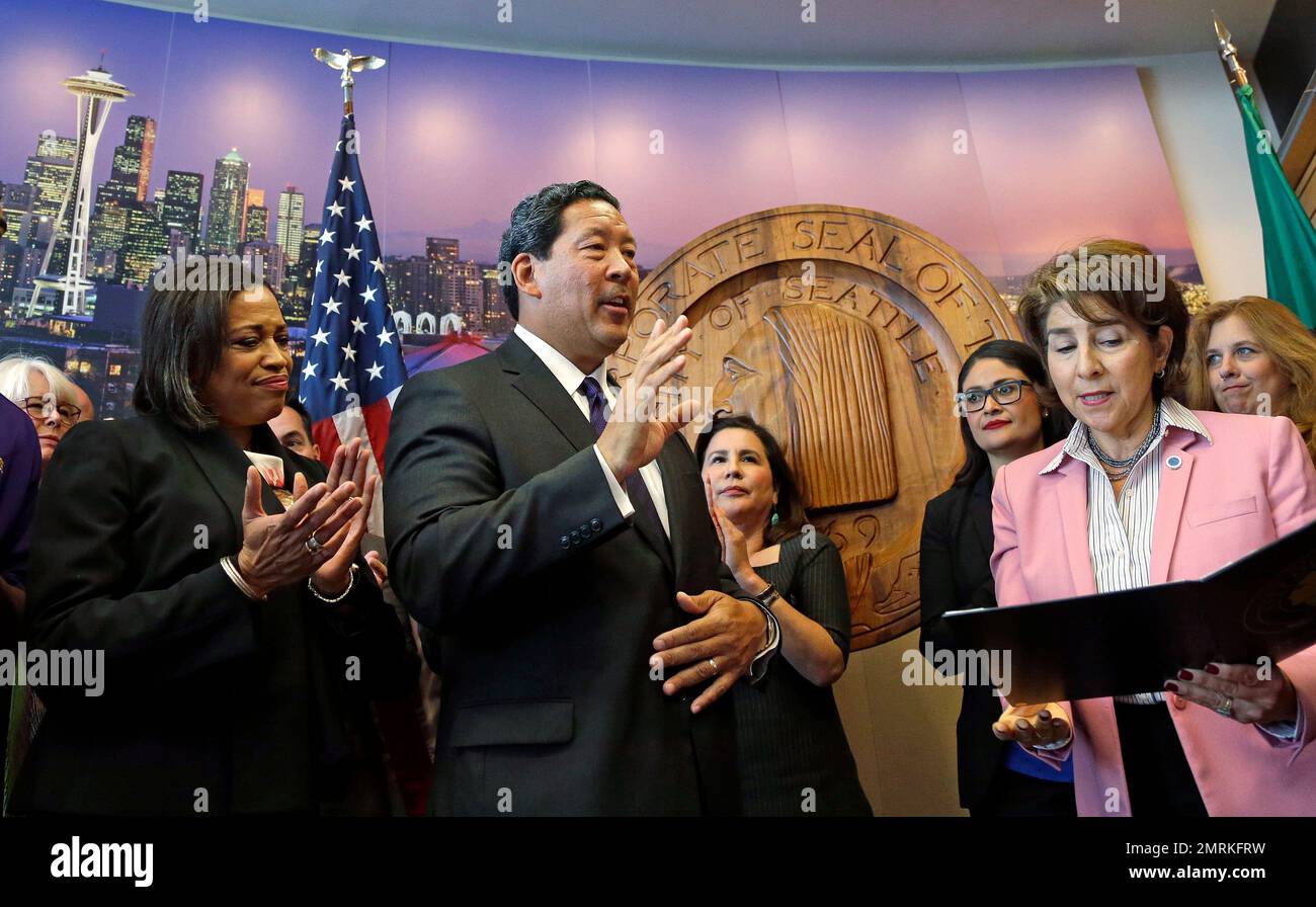 New Seattle Mayor Bruce Harrell, center, gives a wave after taking the ...