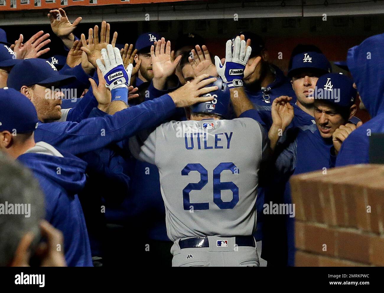 Los Angeles Dodgers' Chase Utley (26) is congratulated after hitting a ...