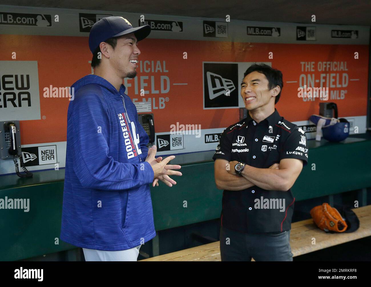Los Angeles Dodgers pitcher Kenta Maeda, left, talks with race car ...