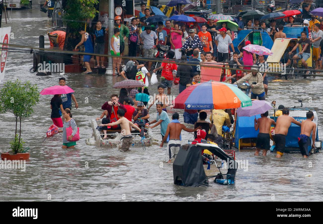 CORRECTS NAME OF TROPICAL DEPRESSION - Residents wade through the flood ...