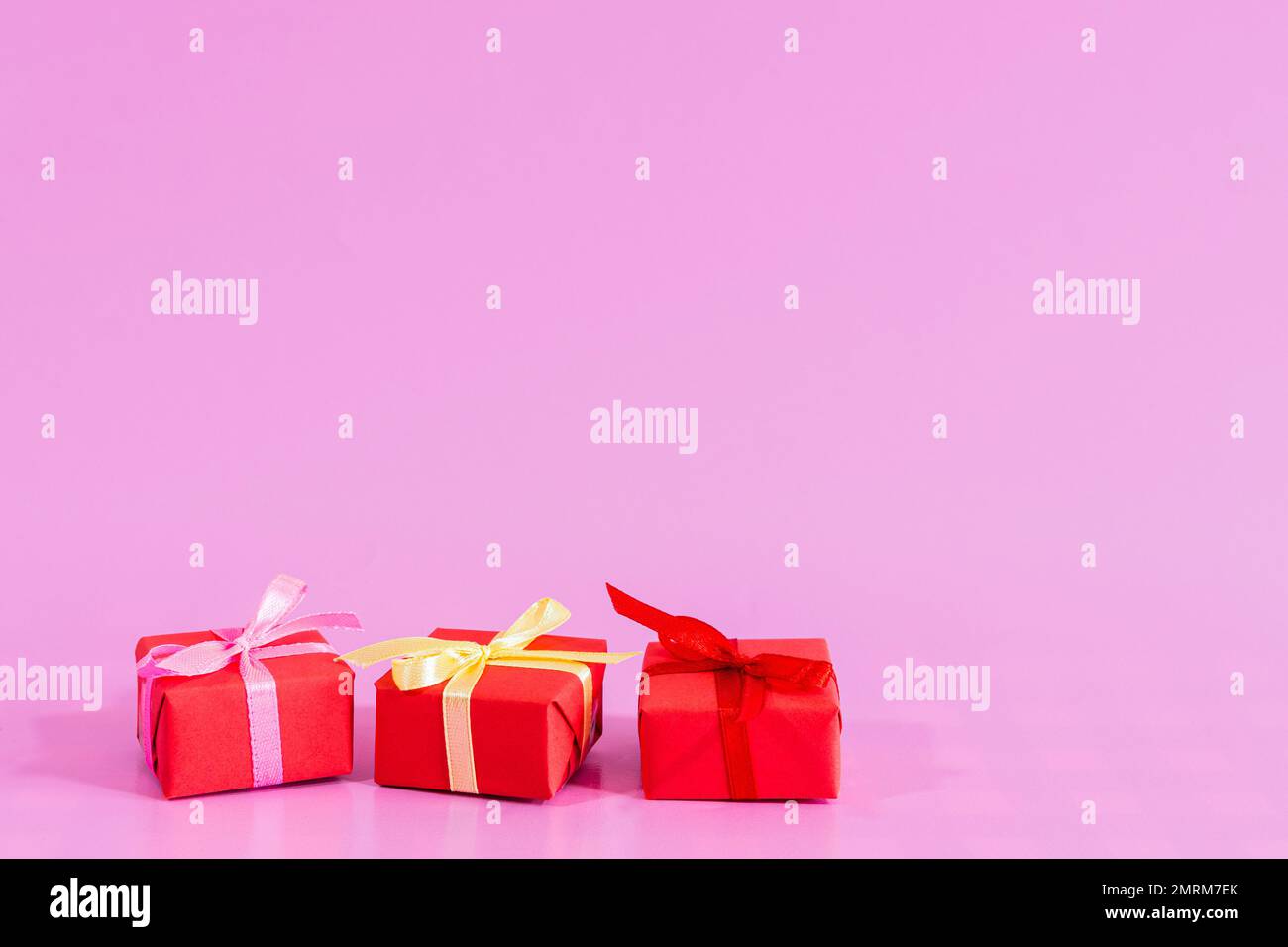 An image of three red boxes on a pink background Stock Photo - Alamy